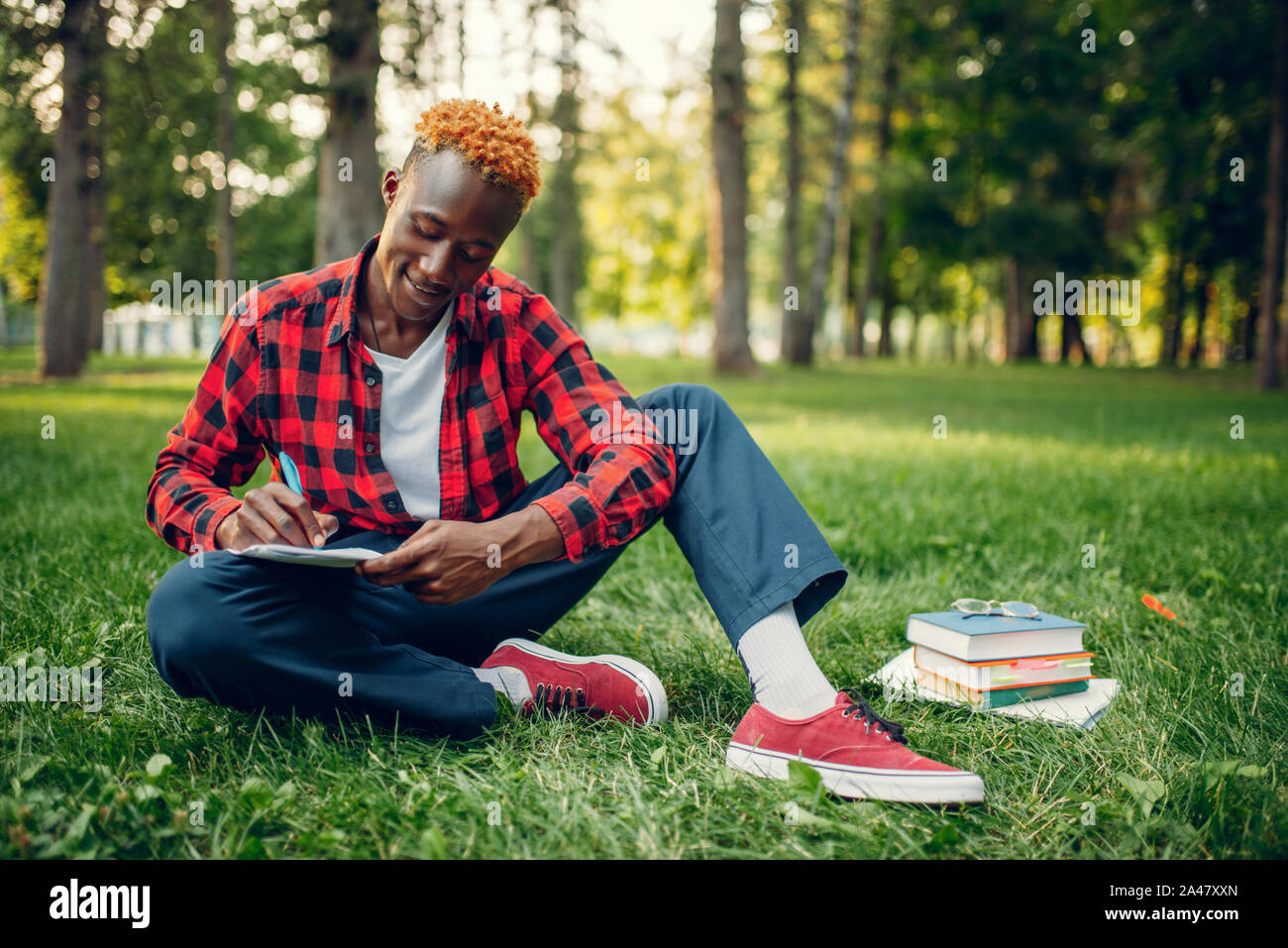 Black student writing hi-res stock photography and images - Alamy