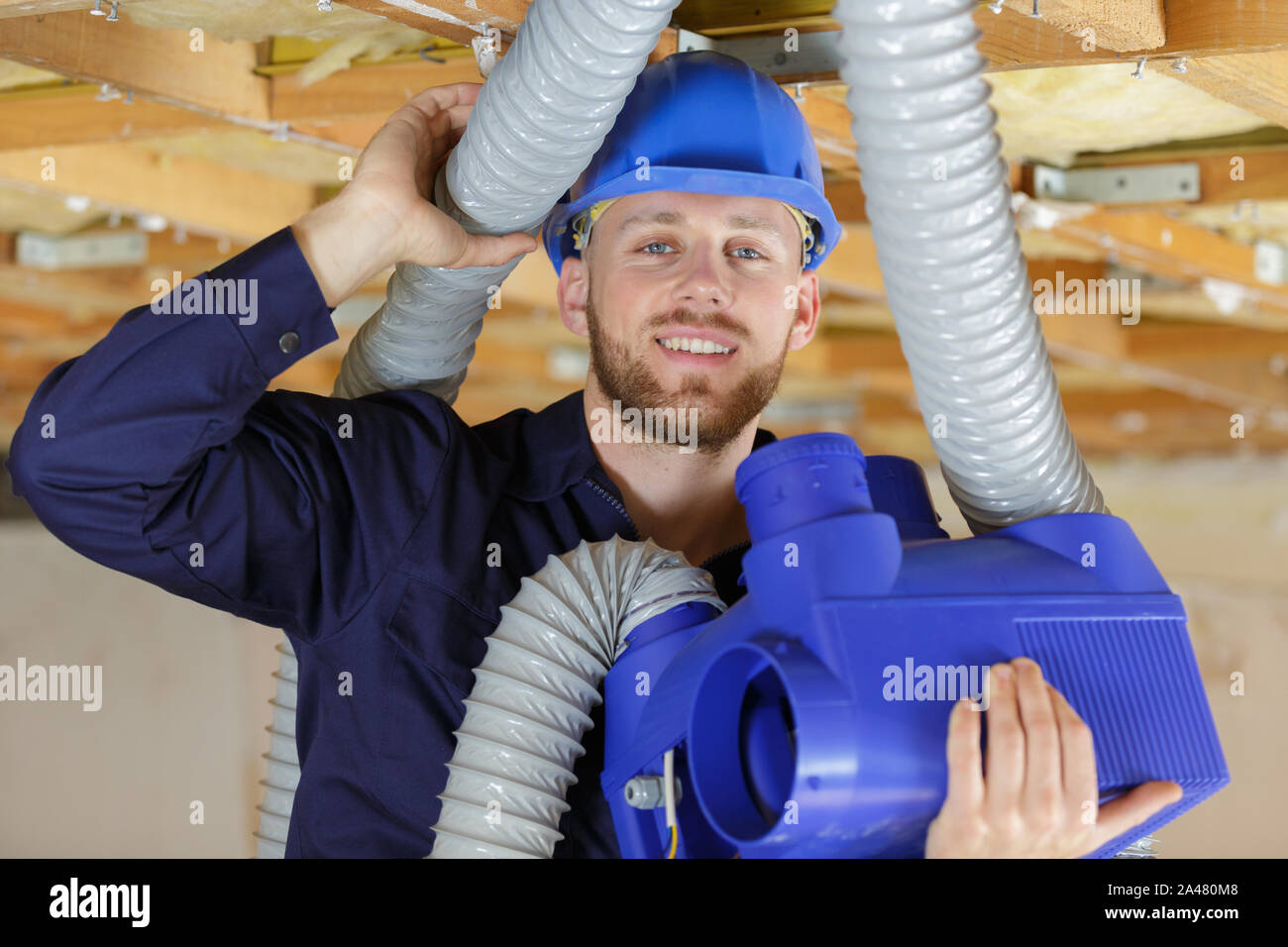 a man installing ventilation system Stock Photo - Alamy