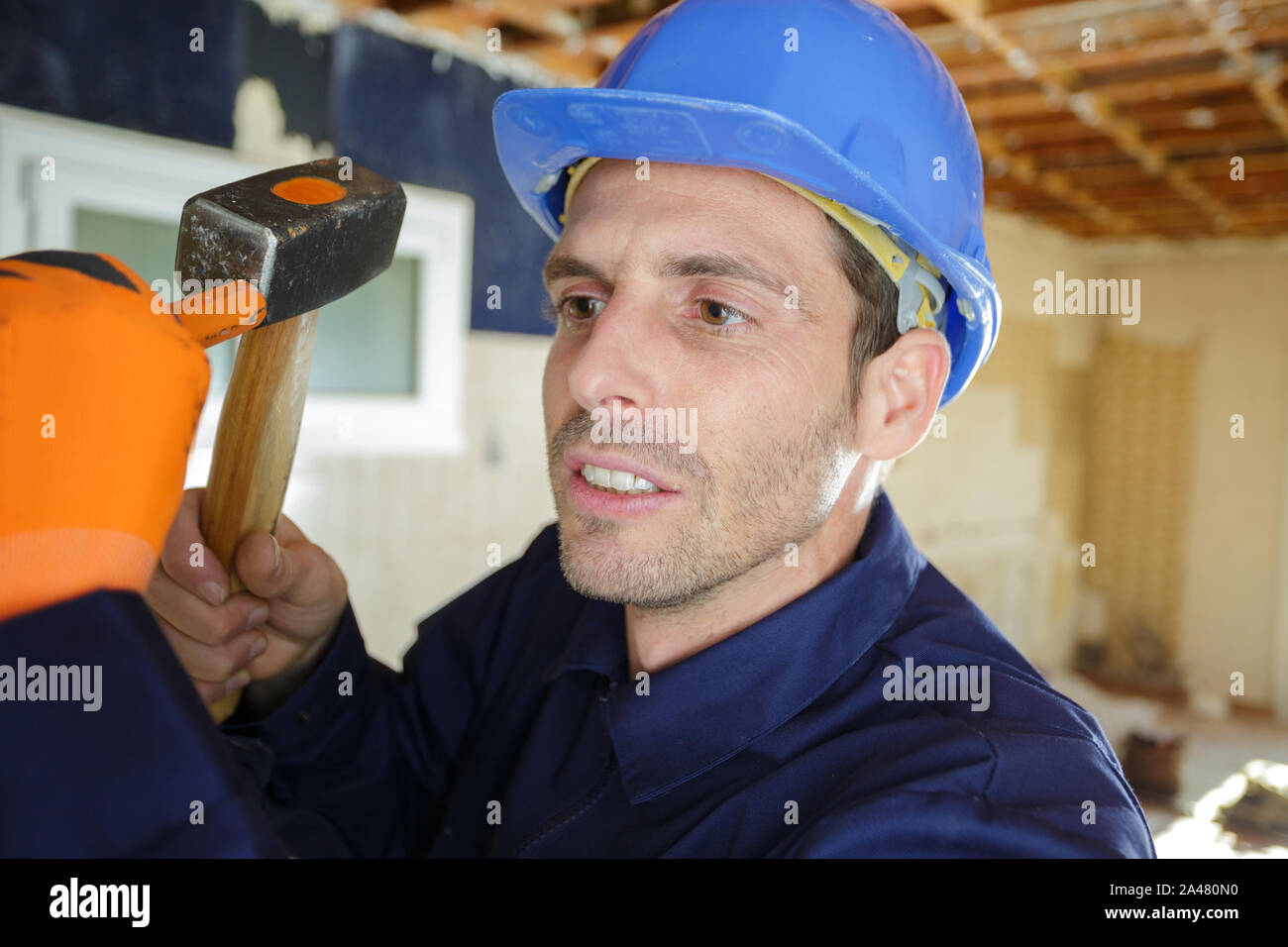 close view of builder using hammer chisel Stock Photo - Alamy