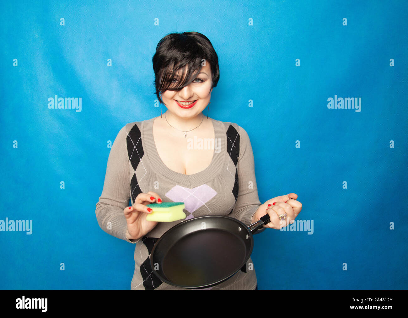 Cleaning dishware kitchen sink sponge washing frying pan. Housewife ...
