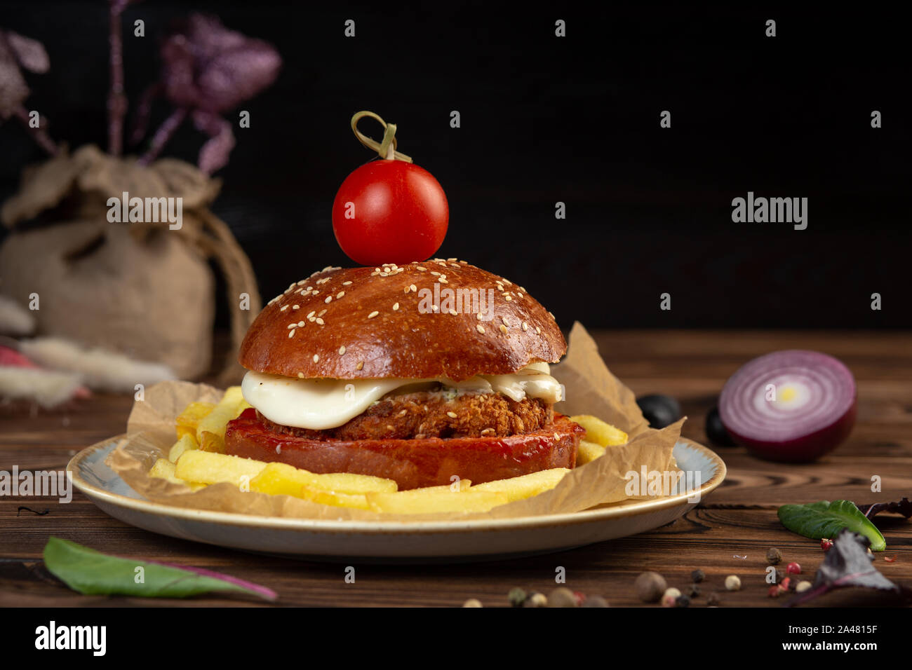 Cheeseburger from chopped beef cutlet with tomato. Dark background ...