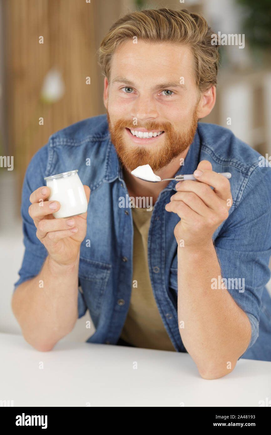 Man eating yogurt breakfast hi-res stock photography and images - Alamy