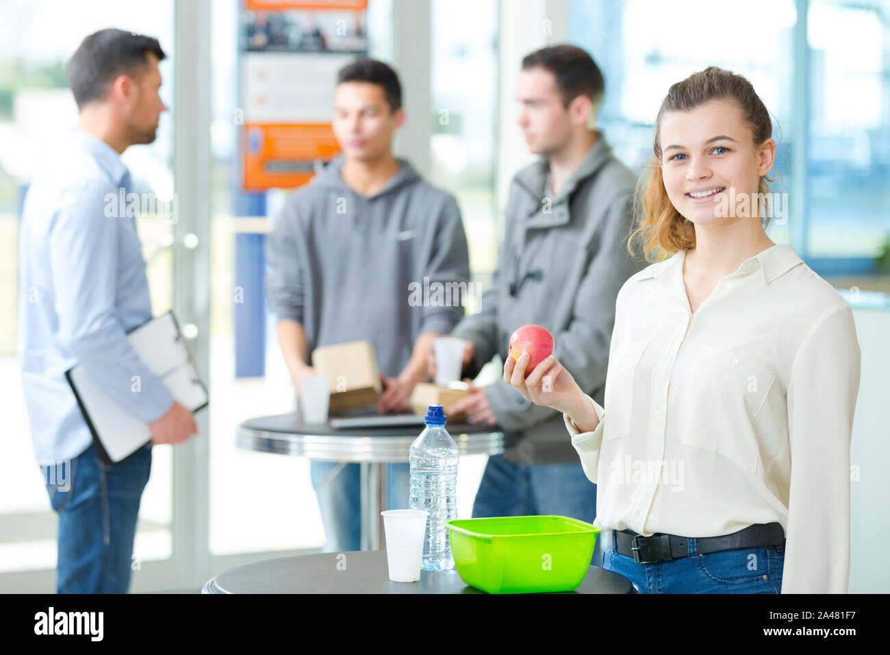 young lady eating apple for lunch Stock Photo - Alamy