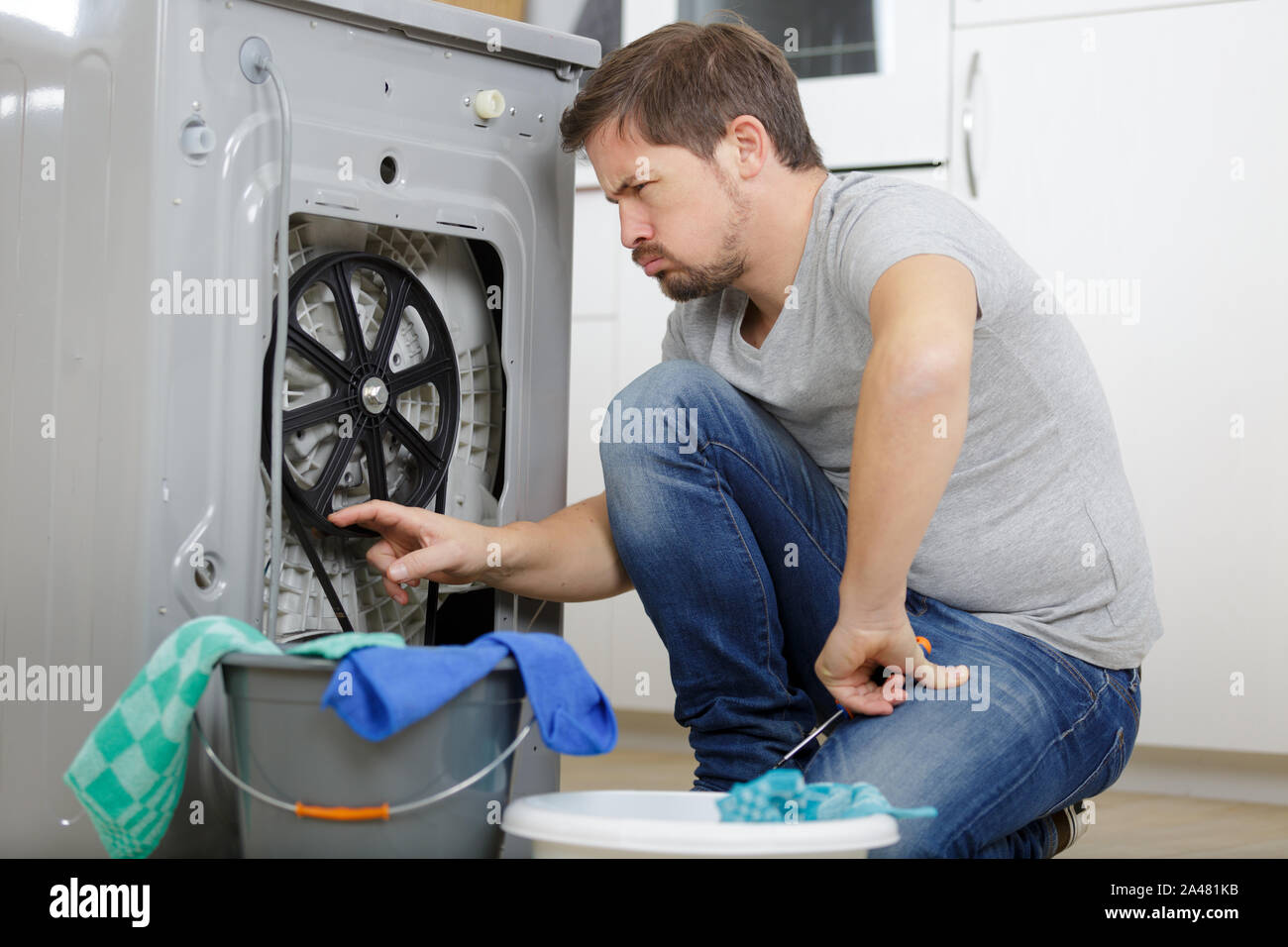 plumber with washing machine problem Stock Photo - Alamy