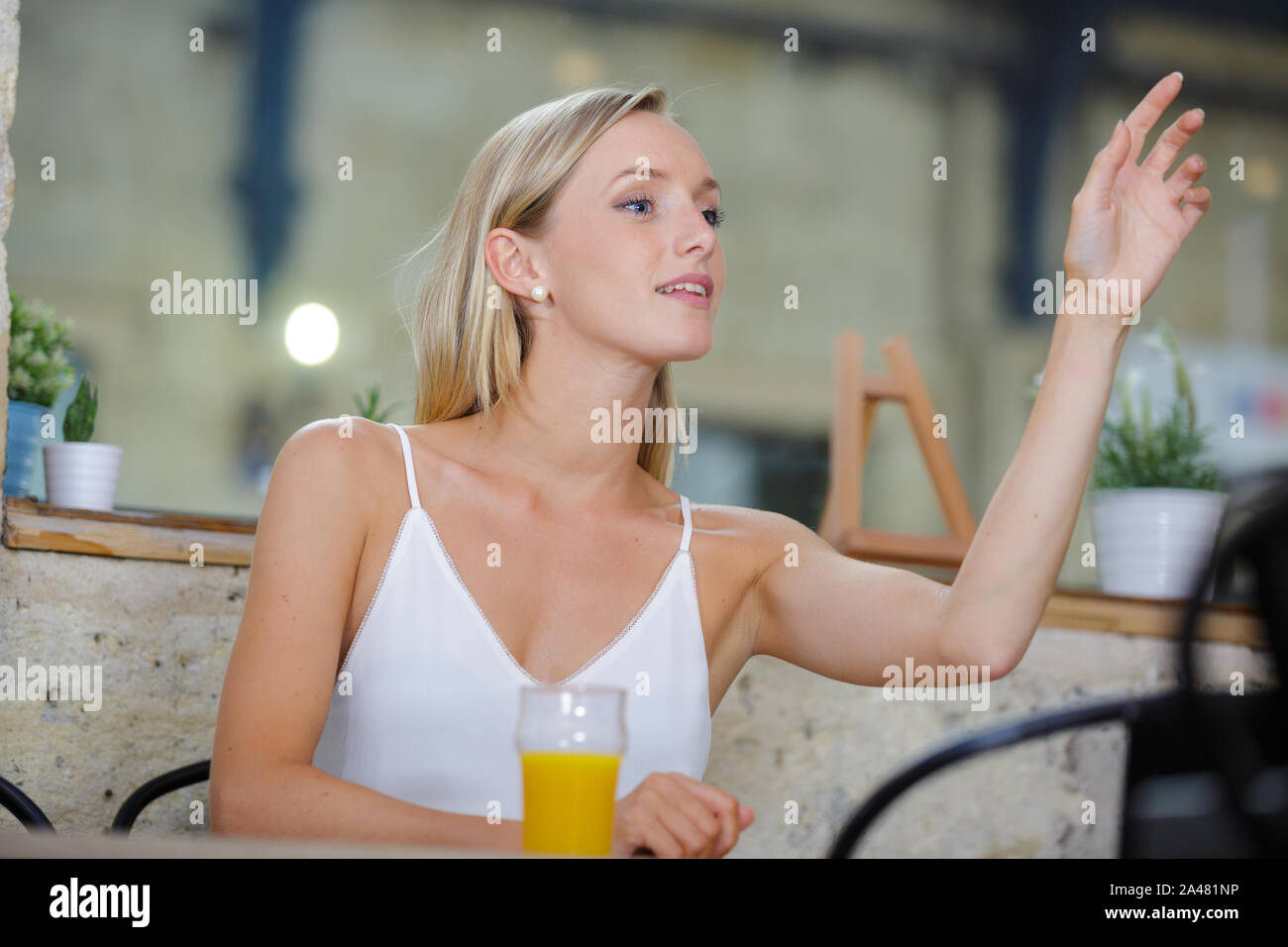 Woman calling waiter hi-res stock photography and images - Alamy