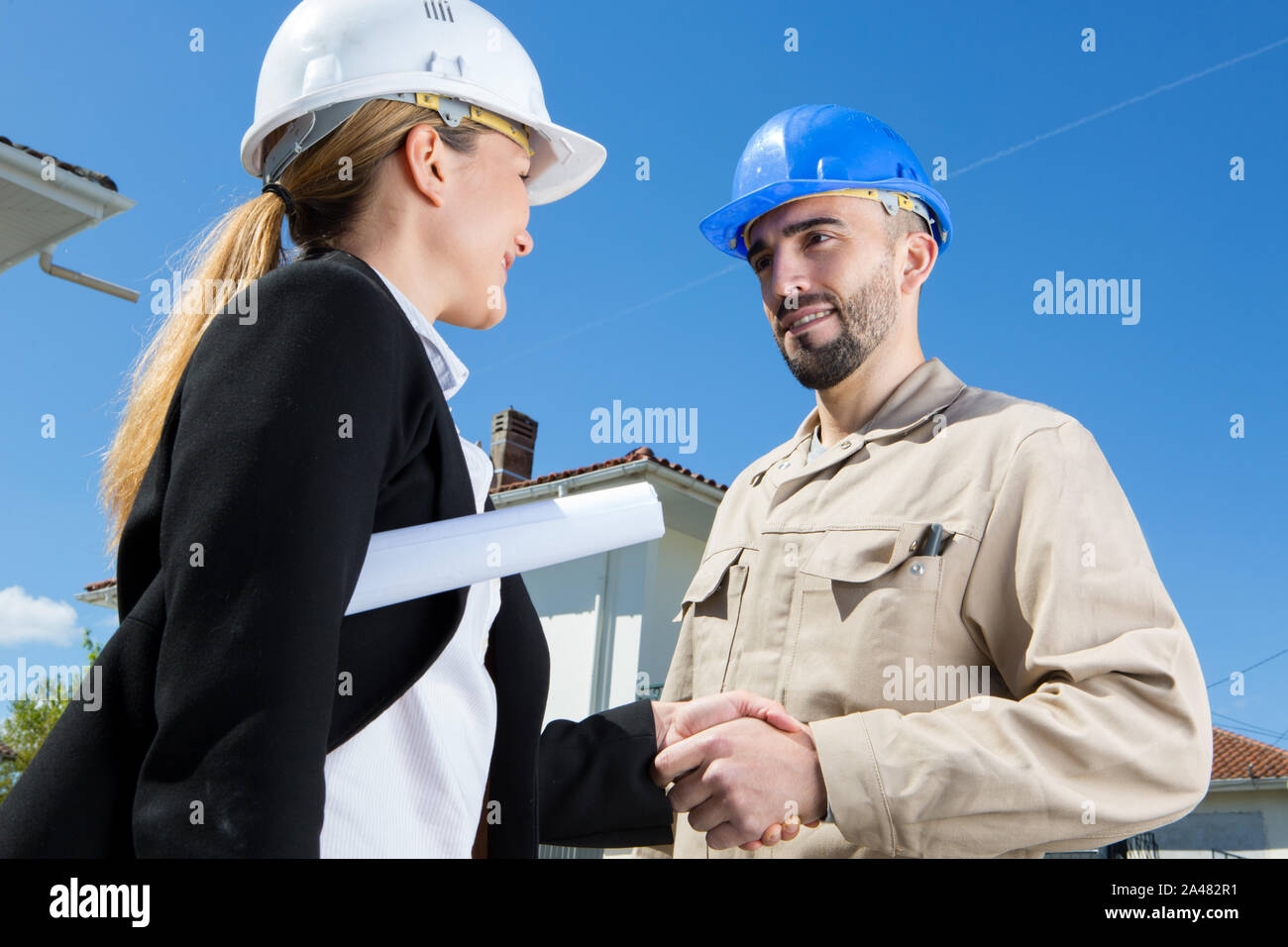 female architect handshakes builder in new building construction Stock ...