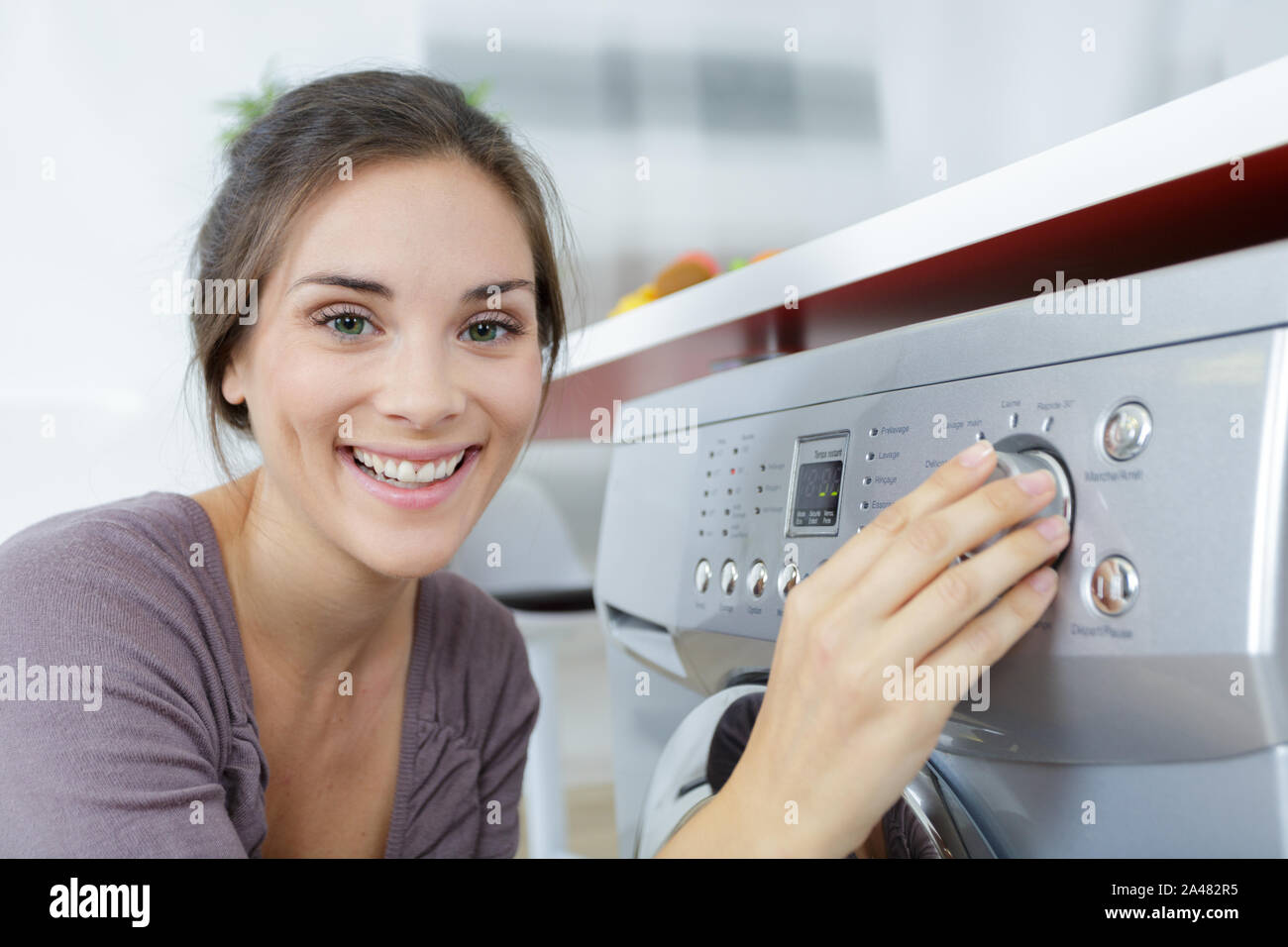 happy housewife woman in laundry room with washing machine Stock Photo ...