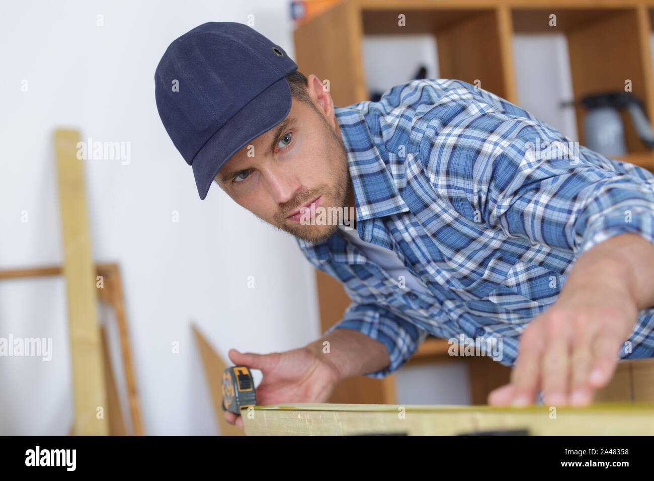 man measuring length of wood Stock Photo - Alamy