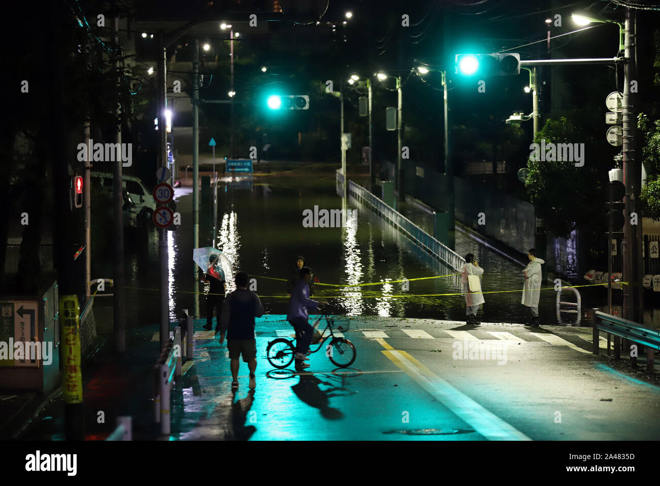 Tokyo, Japan. 12th Oct, 2019. A road is covered with flooded water at ...