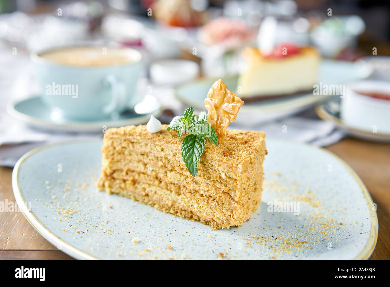 Honey sponge cake decorated with meringue and mint leaves.. Breakfast ...