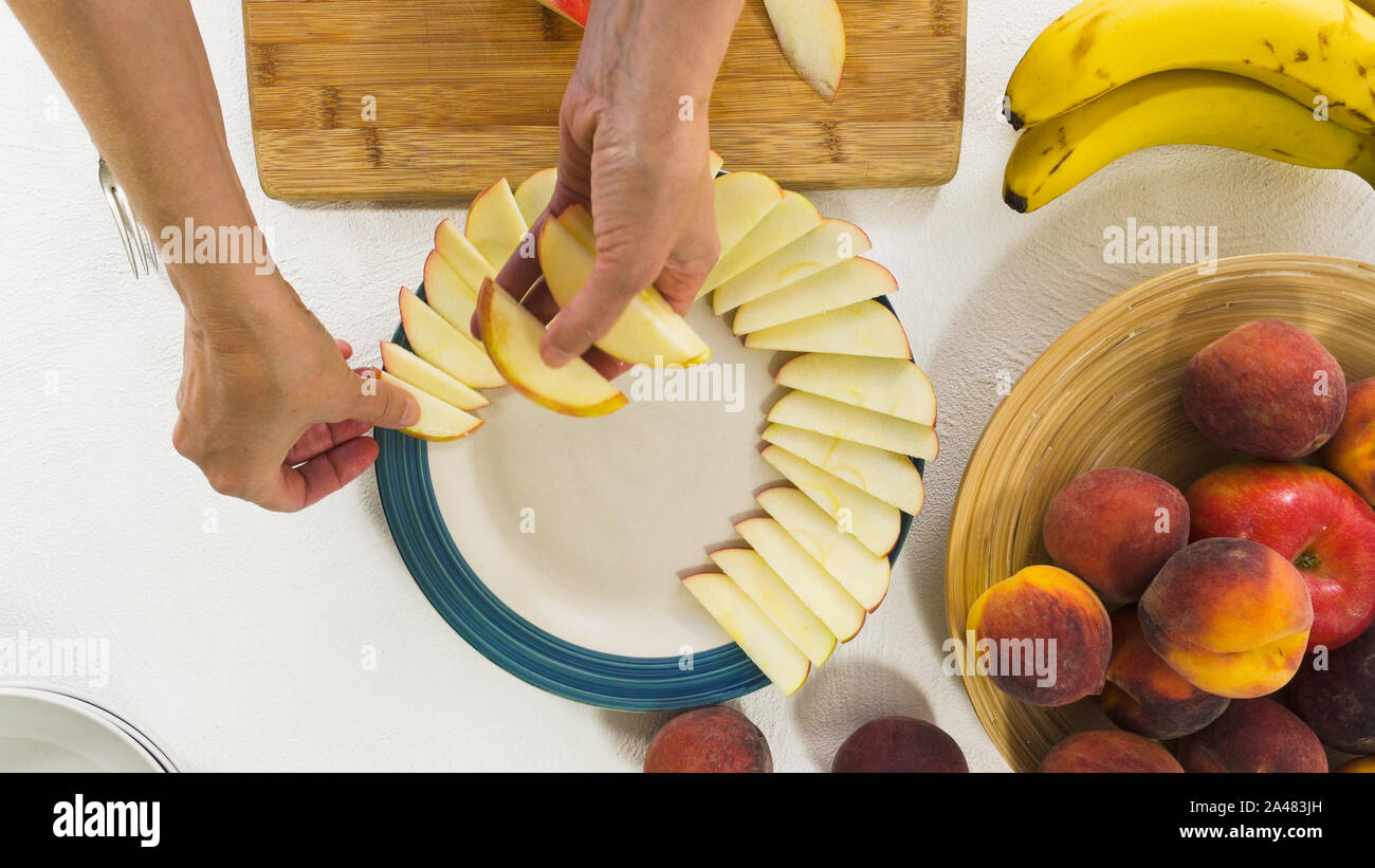 Apple slices on a plate, top view, white background Stock Photo - Alamy