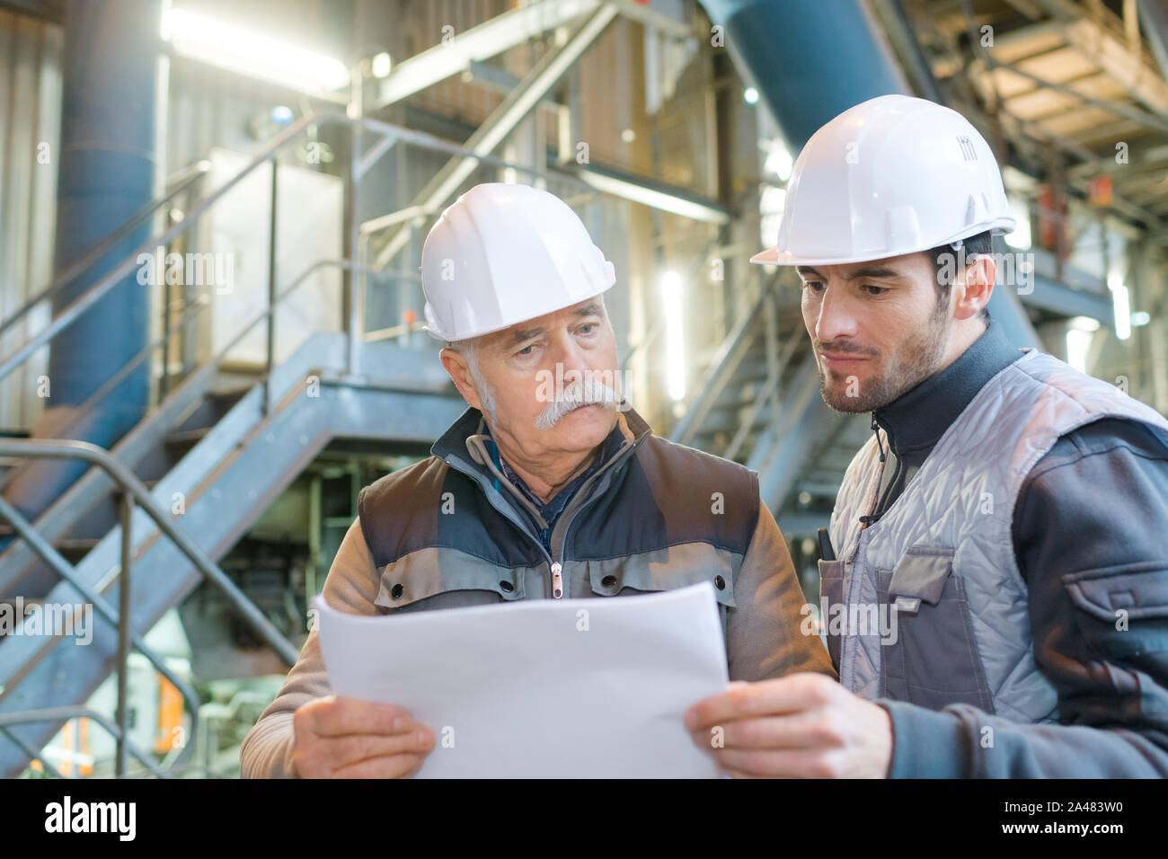 worker and manager at factory Stock Photo - Alamy
