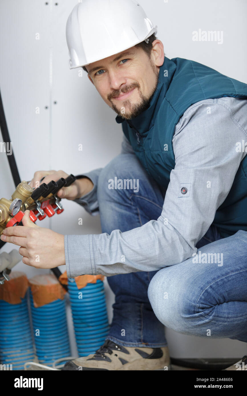 man worker dealing with pipes connection Stock Photo - Alamy