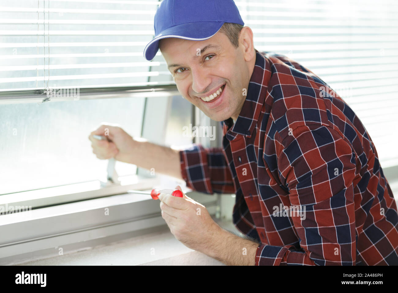 construction worker installing window in house Stock Photo - Alamy