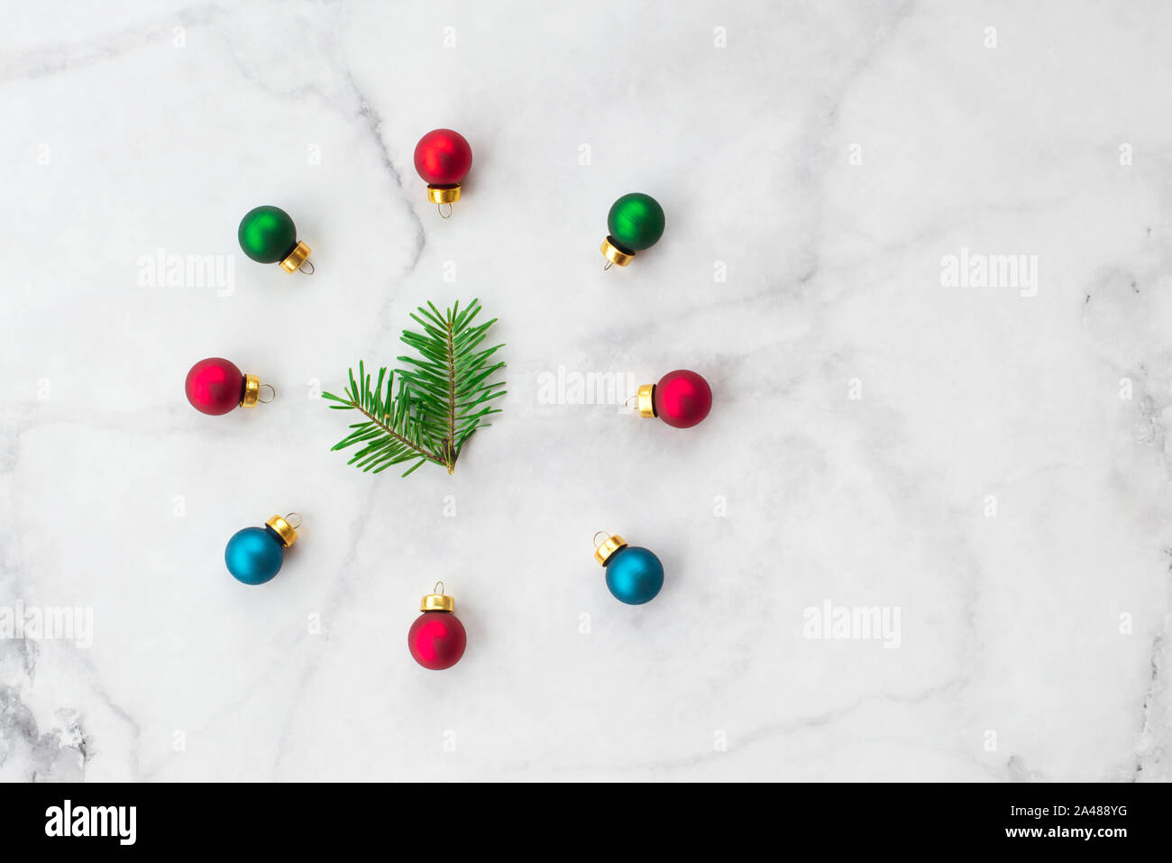 Stylized Christmas clock made of fir-tree branch with blue and red ball ...