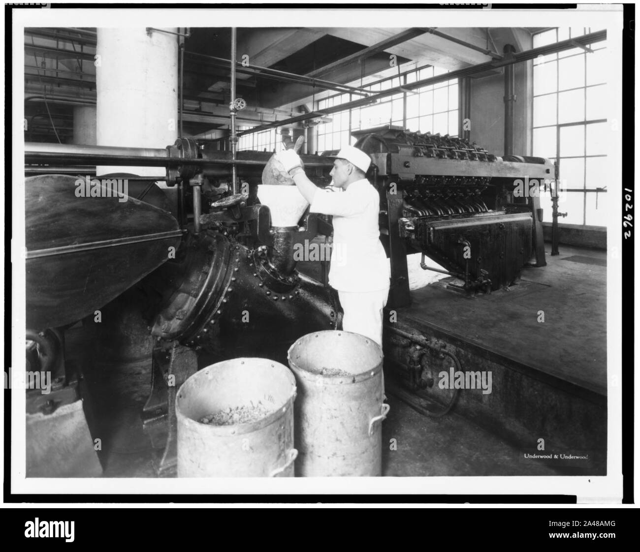 Filling the hopper. Chicle refining at American Chicle Company plant ...