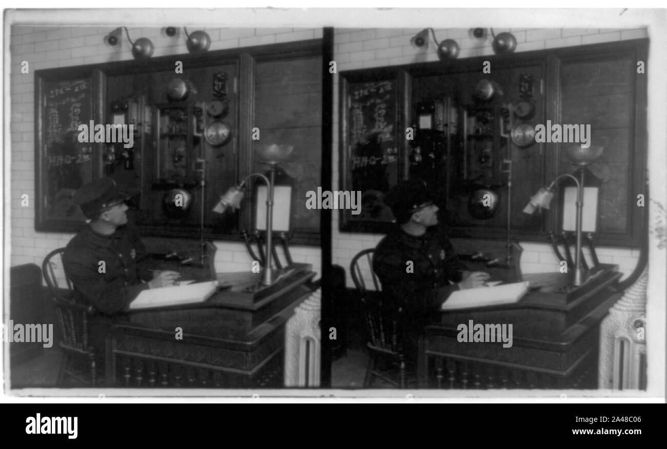 Fireman at desk in front of fire alarm Stock Photo - Alamy
