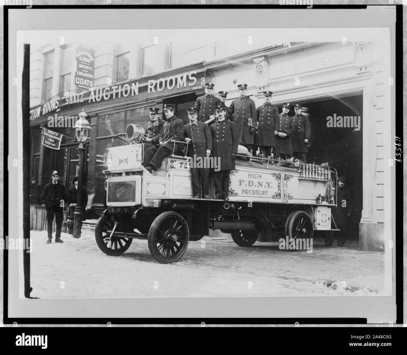 Firemen posed on fire engine, New York City Stock Photo - Alamy