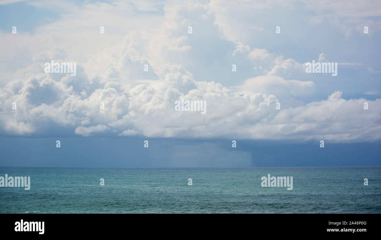 Many shades of blue in this scene, bluegreen sea water in front of low ...