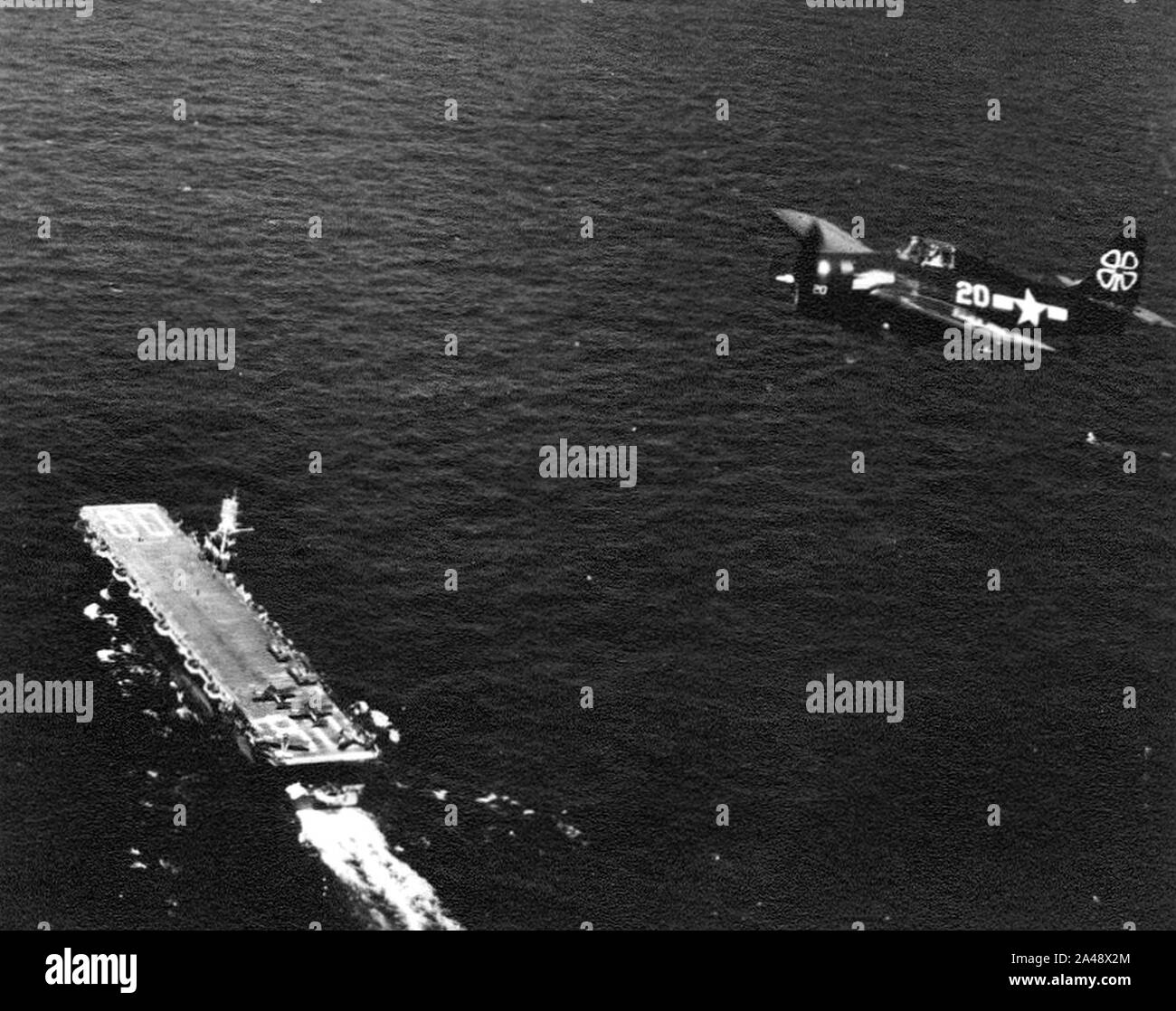 FM-2 Wildcat of VC-93 in flight over USS Petrof Bay (CVE-80) off ...