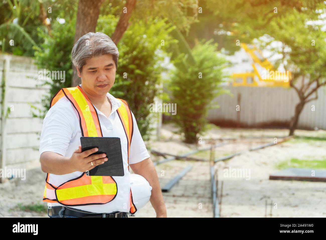 Engineering wearing a white safety helmet standing In front of the ...