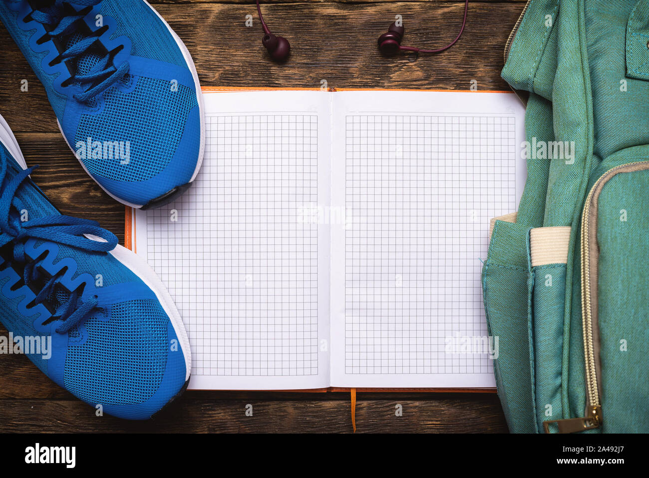 Blank fitness gym exercise list with blank pages, sneakers and bag on a ...