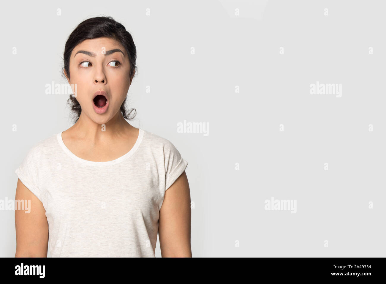 Shocked indian girl amazed looking aside on blank copy space Stock ...