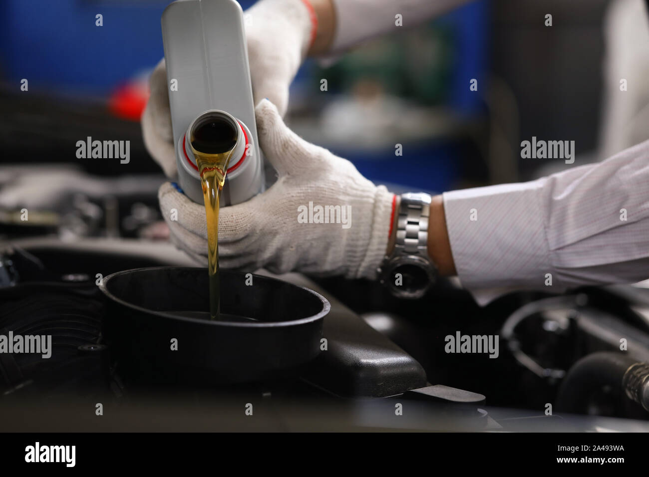 Pouring new oil Stock Photo - Alamy
