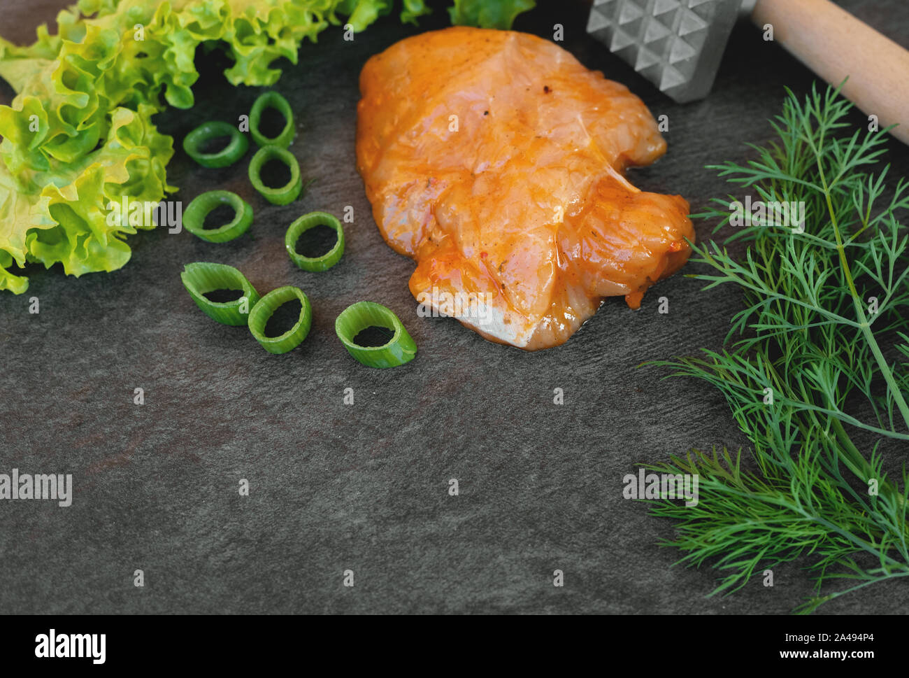 Slice of pickled turkey fillet on a kitchen cutting board background ...