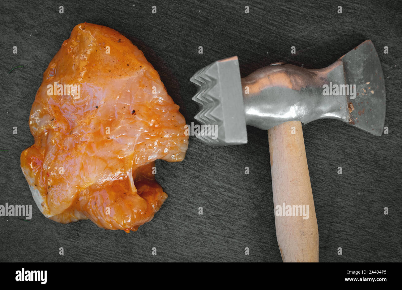 Slice of pickled turkey fillet on a kitchen cutting board background ...