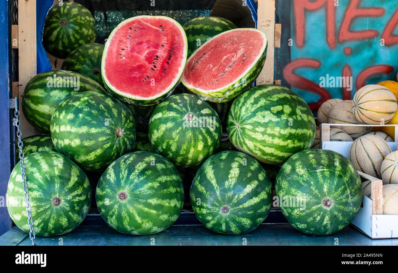 Watermelons on shelf. Cutted watermelon on street market. Summer Fruits ...