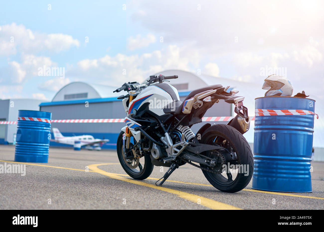 sports motorcycle next to the background of the plane Stock Photo - Alamy