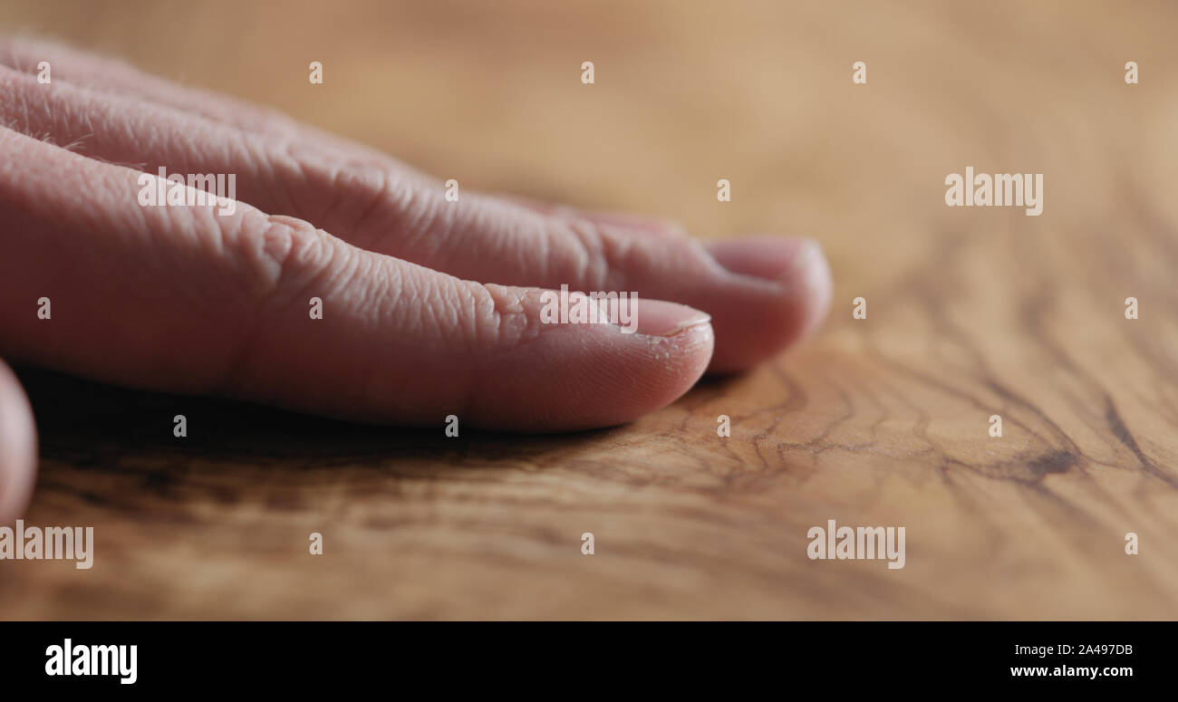 man hand touch oil finished olive wood surface, wide photo Stock Photo ...