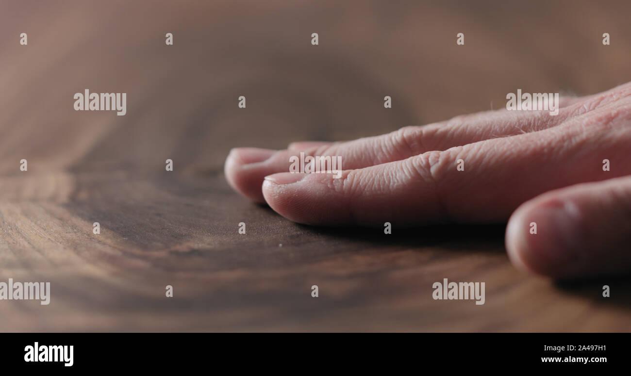 man hand touch oil finished black walnut wood surface, wide photo Stock ...