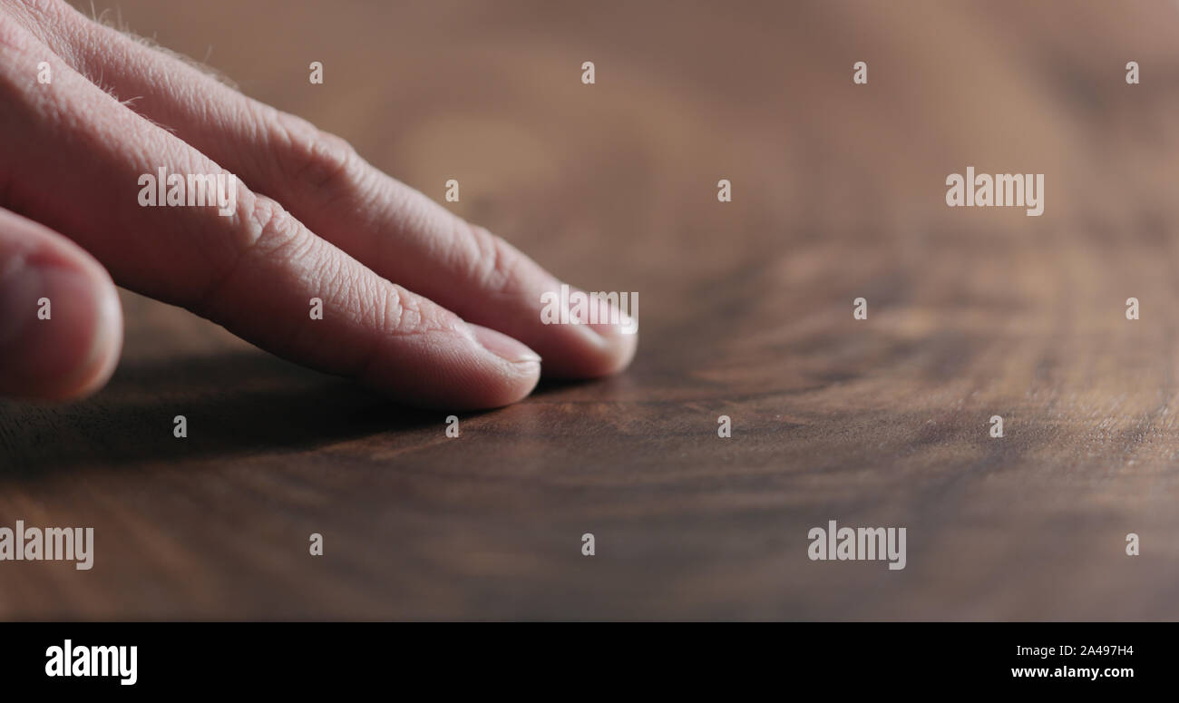 man hand touch oil finished black walnut wood surface, wide photo Stock ...
