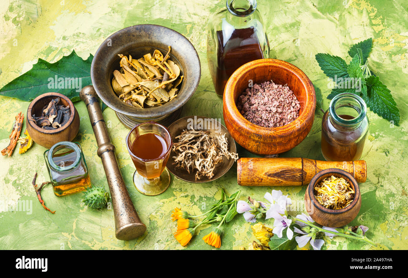 Bottles of tincture and healthy herbs.Assorted natural medical herbs ...