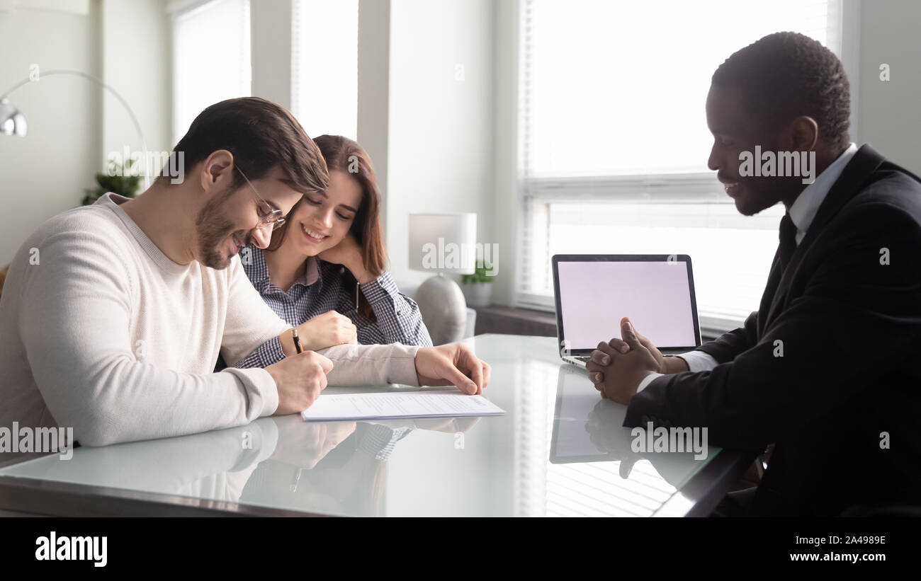 Side view happy young family couple signing contract Stock Photo - Alamy