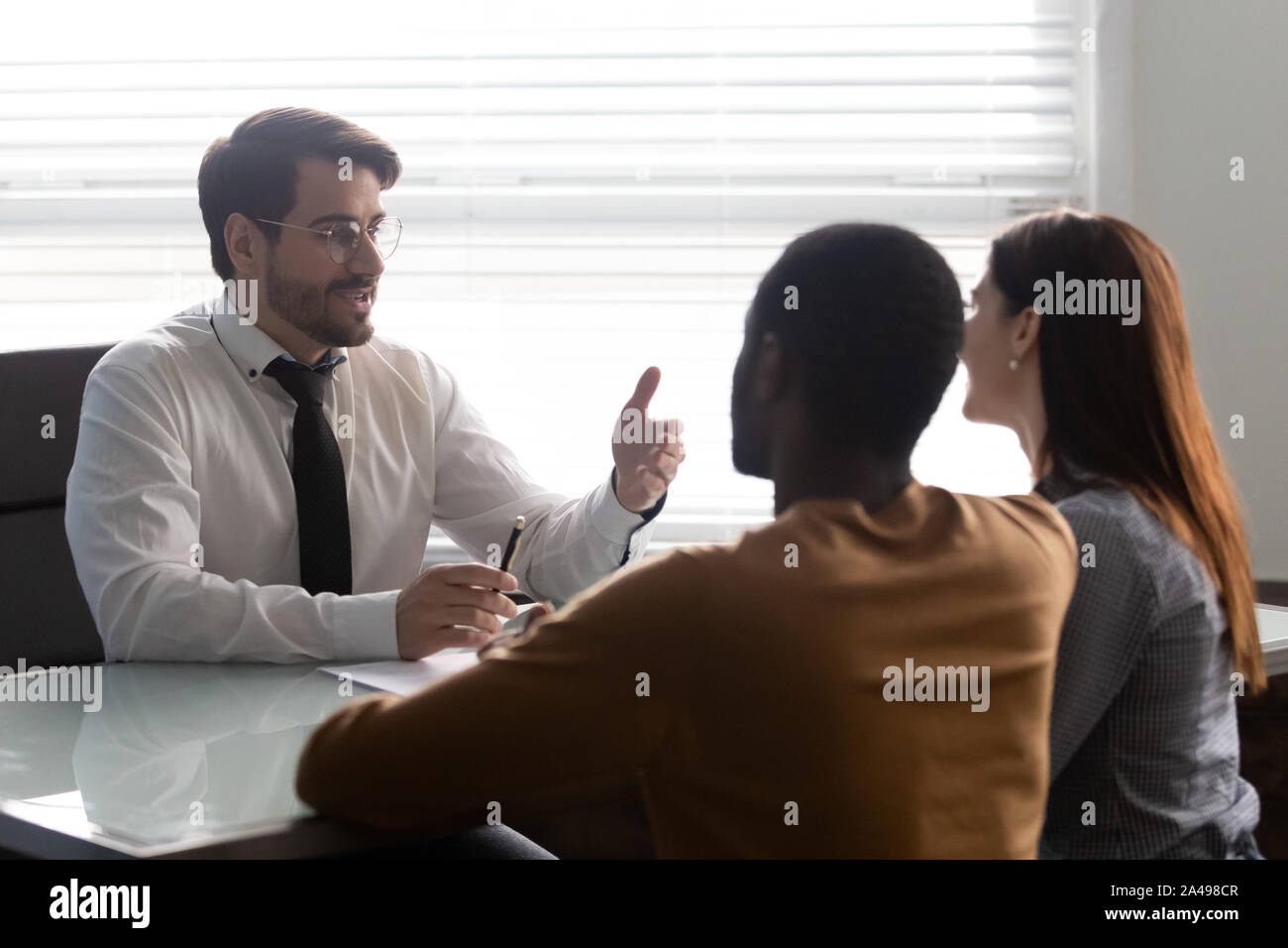 Financial expert explaining contract details to involved multiracial ...