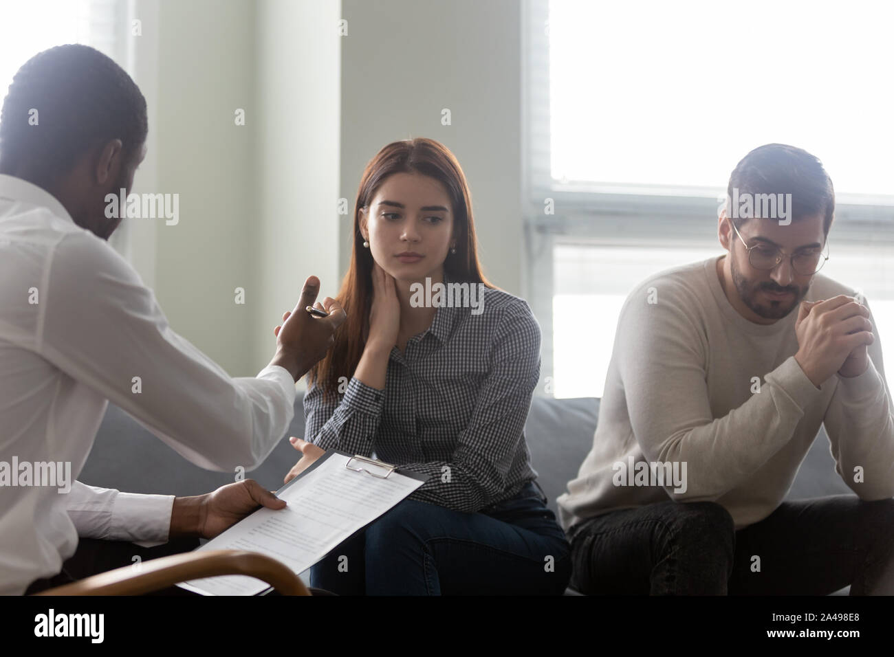 Psychologist asking questions to frustrated young woman Stock Photo - Alamy