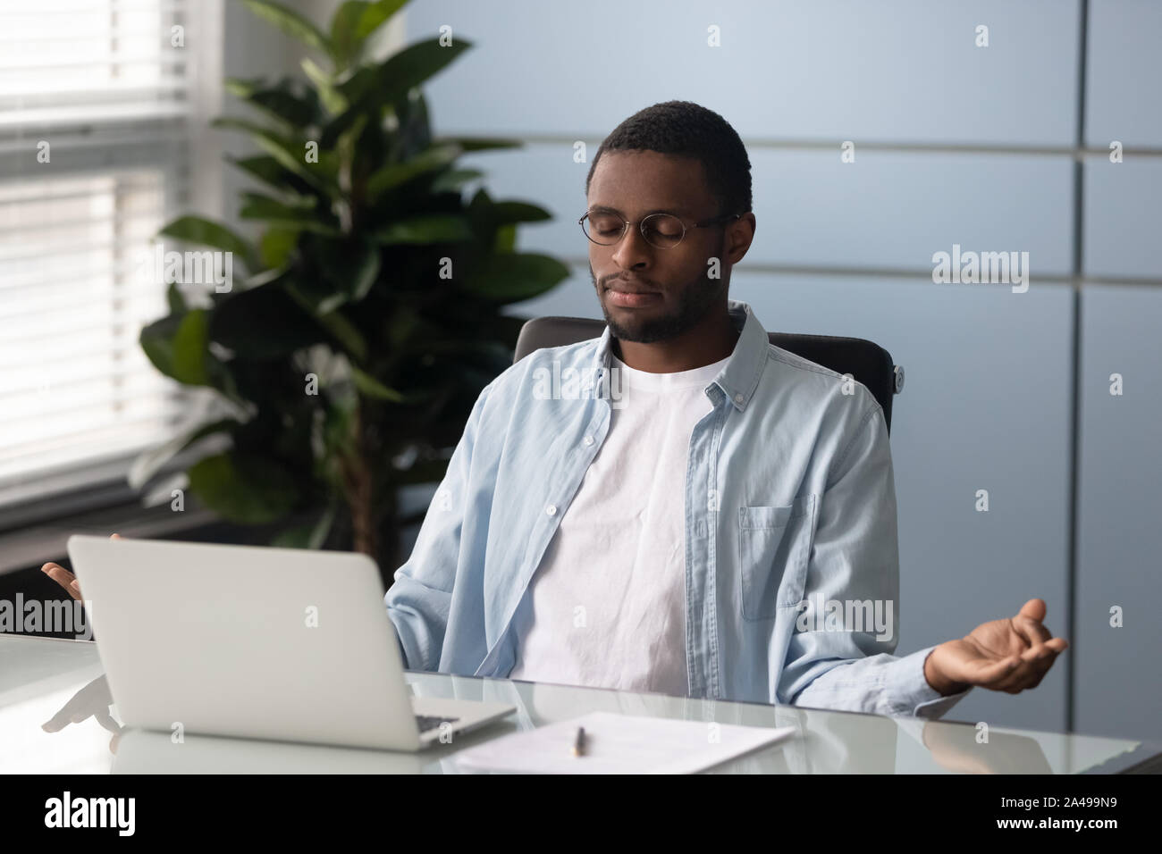 Mindful african american millennial manager relaxing after hard ...