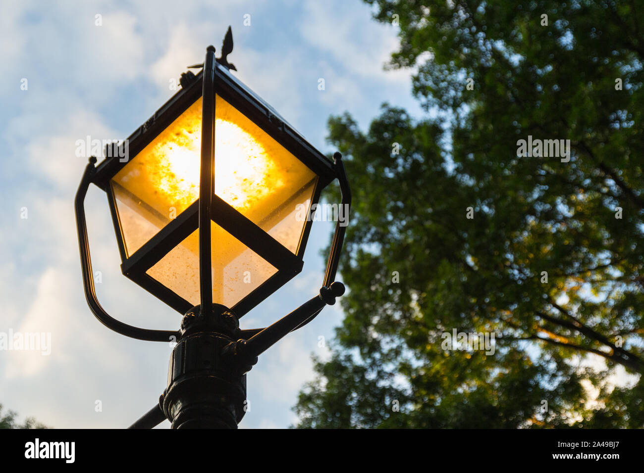 Beautiful steel street lamp in New York City (NYC, USA). Cloud, trees ...