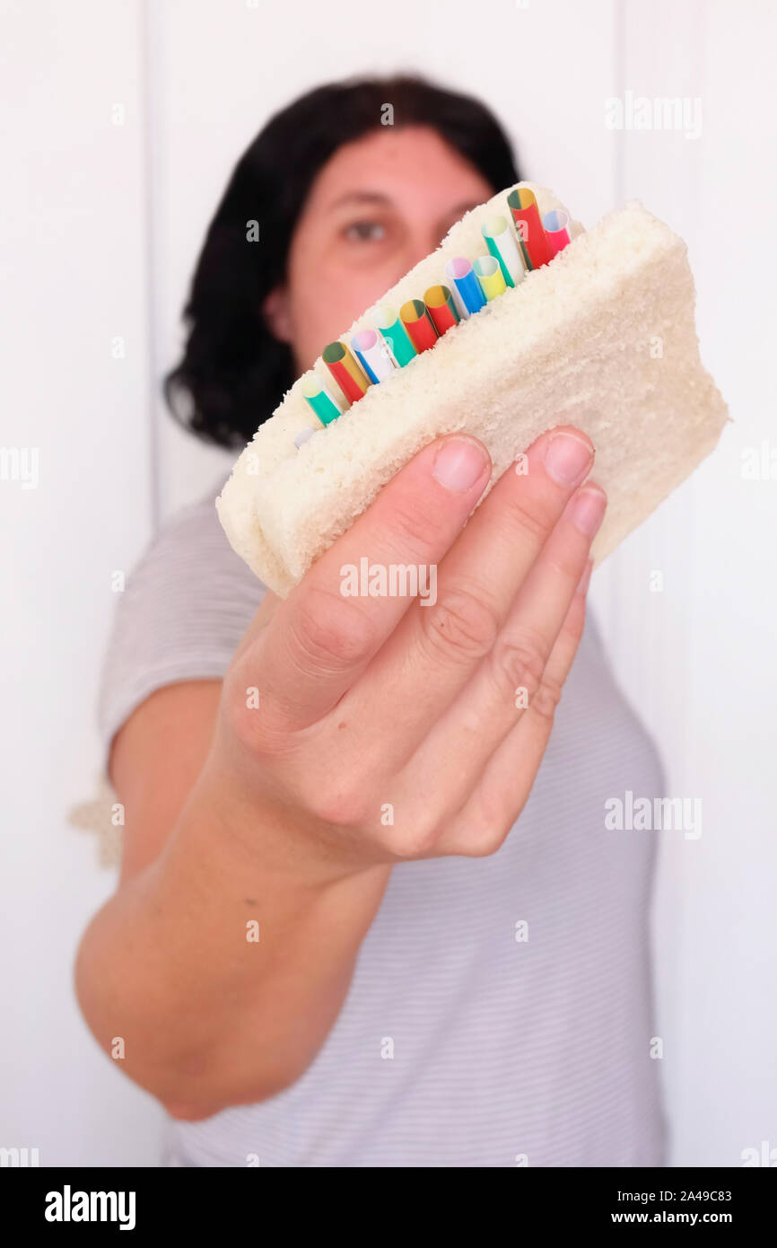 Woman eating plastic.Environmental concept Stock Photo - Alamy