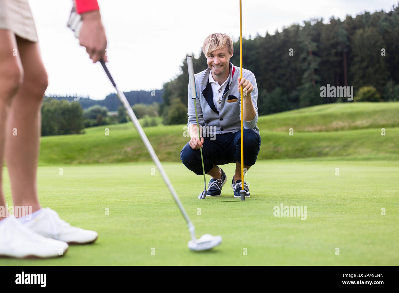 Two friends playing golf Stock Photo - Alamy