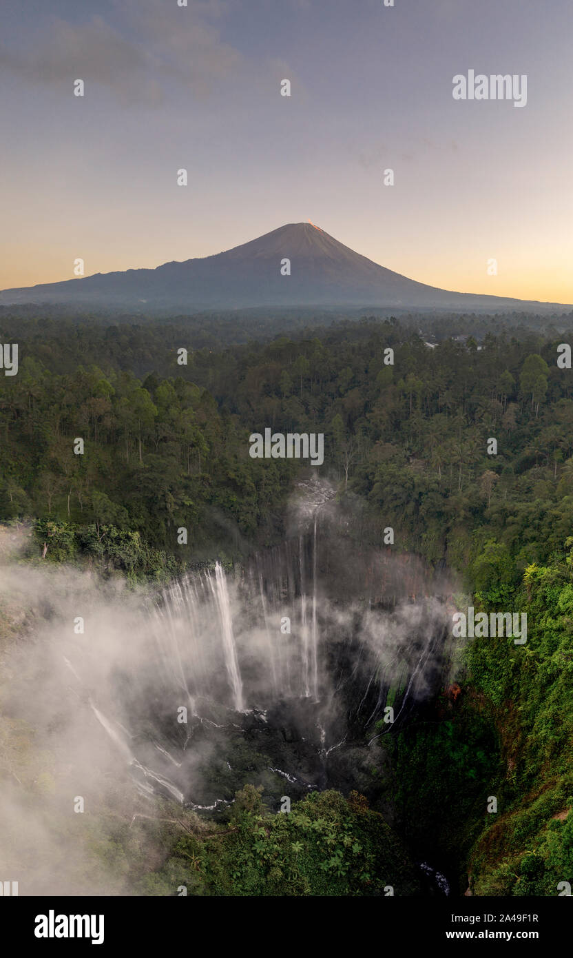 Aerial drone image of Tumpak Sewu waterfall with Mount Semeru volcano ...