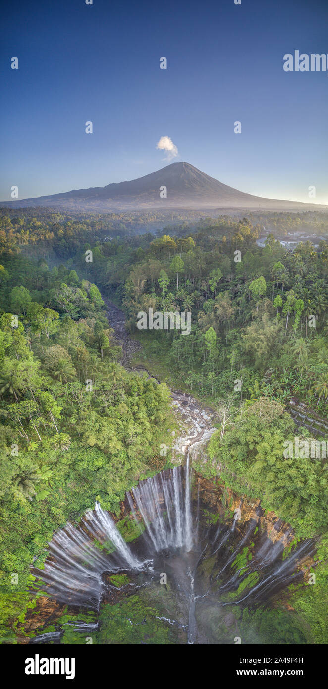 Aerial drone image of Tumpak Sewu waterfall with Mount Semeru volcano ...