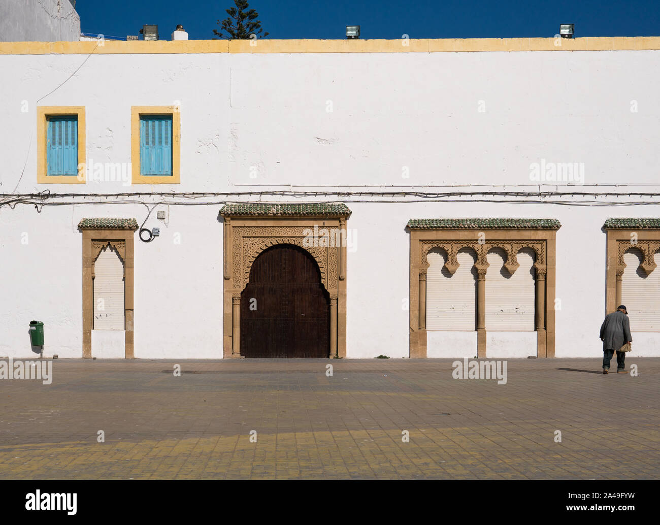 White building with traditional wooden arch door on the main square in ...