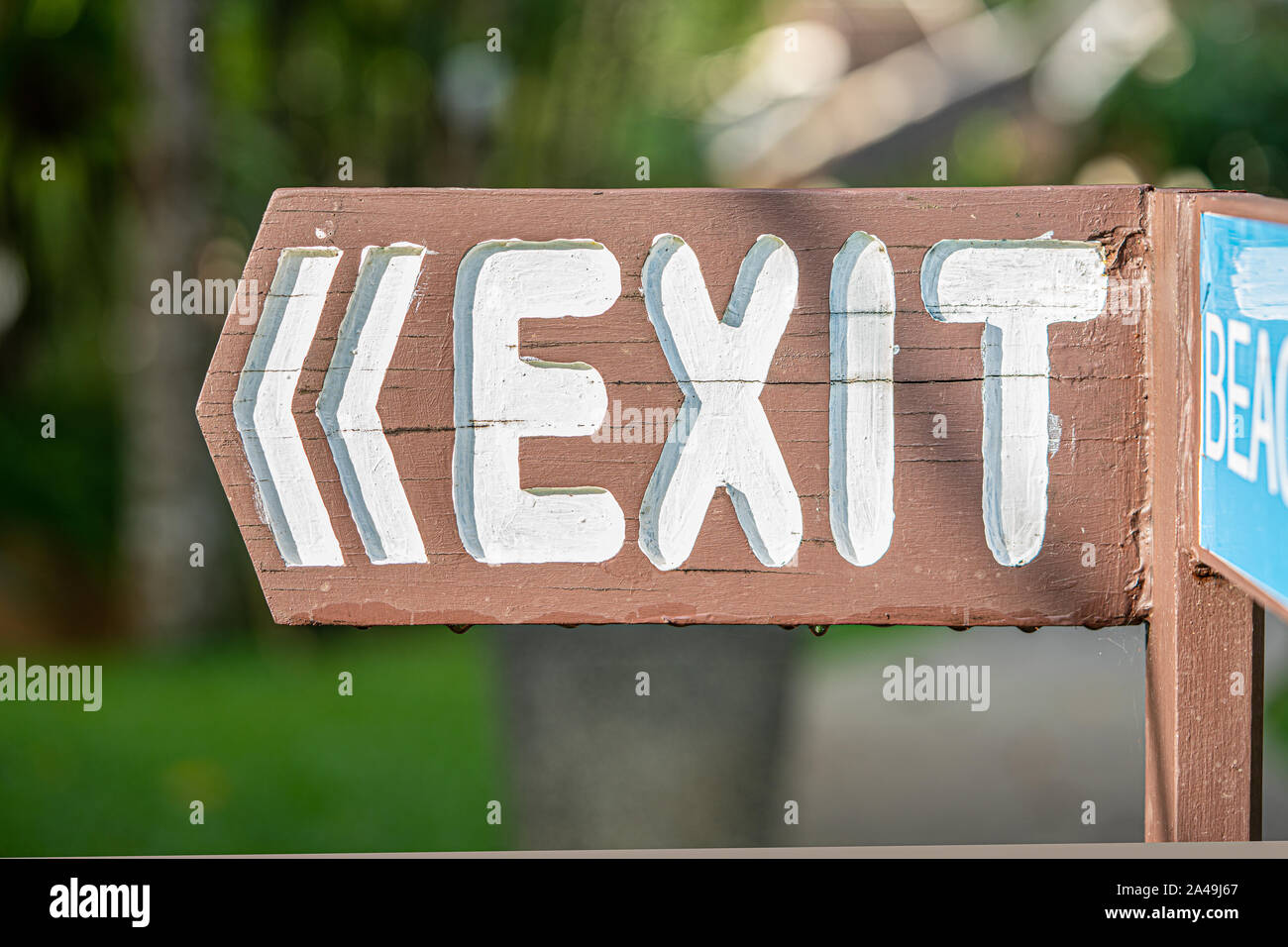 exit sign on a wooden plank, old, vintage, left direction sign, against ...