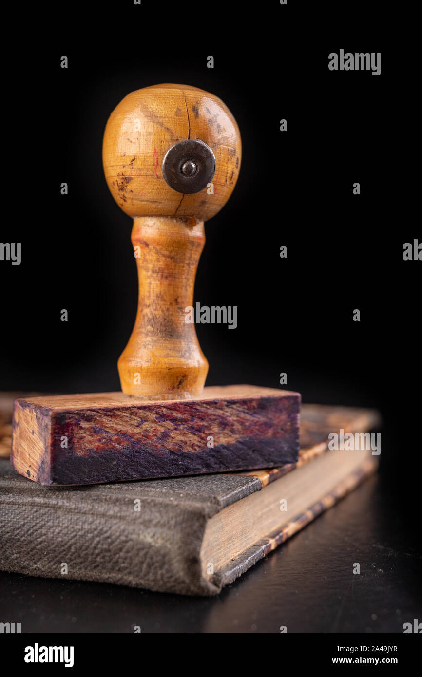 Old wooden rubber stamp on the book. Office accessories used in the ...