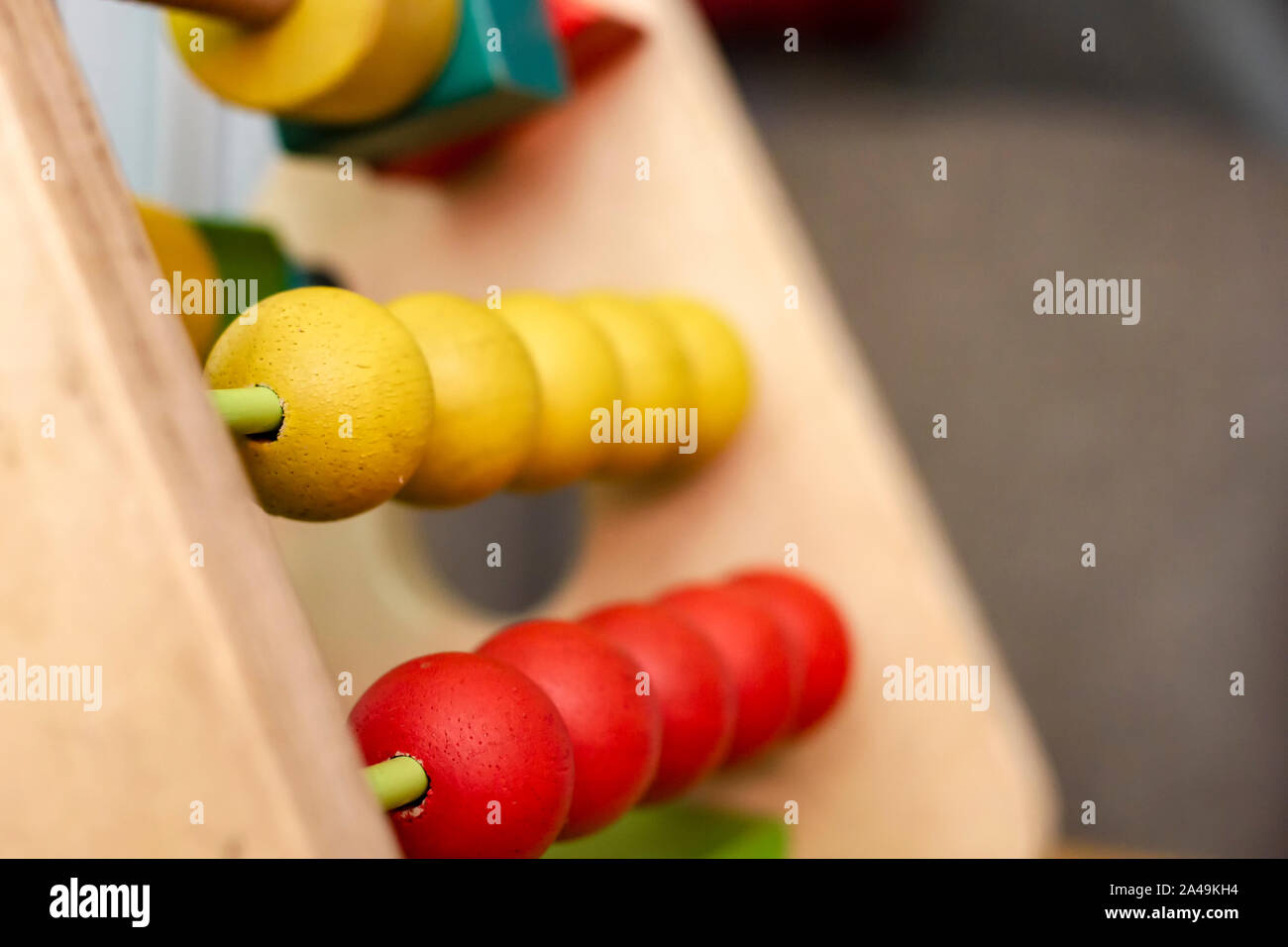 Children's toy. Yellow and red wooden balls on metal rods, teach your ...