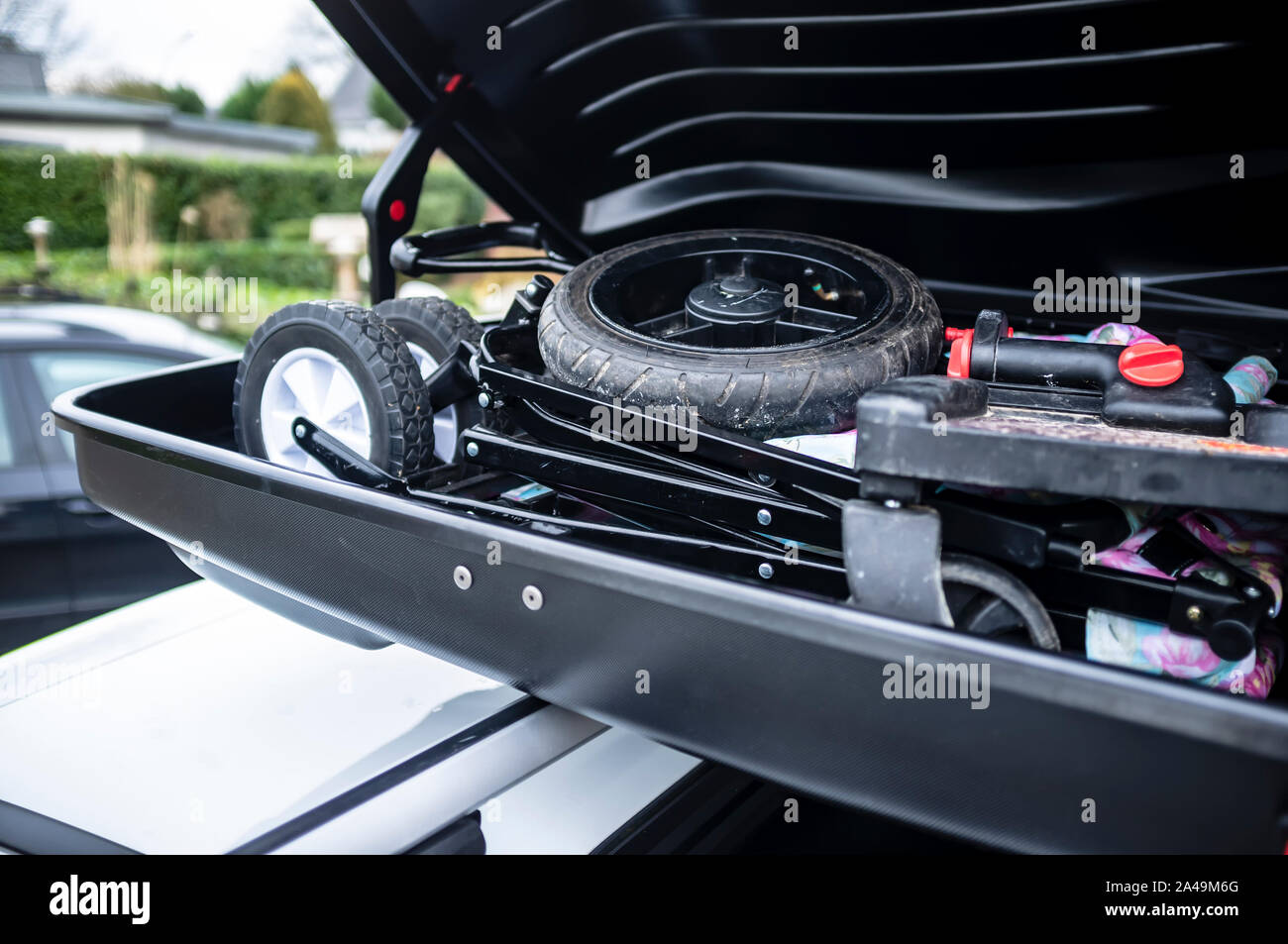 Baby carriage lies in the open trunk or cargo box on the roof of the ...
